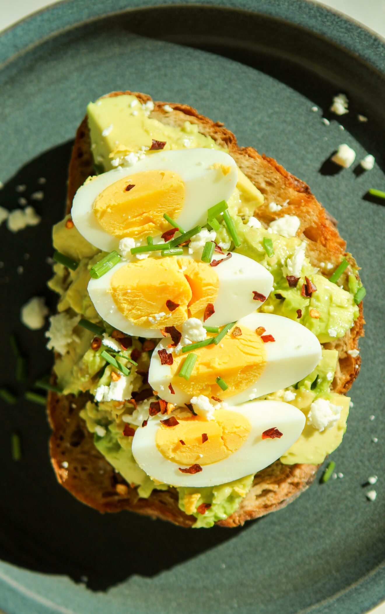 Avocado Toast with Eggs Feta Cheese and Chives - Mozie